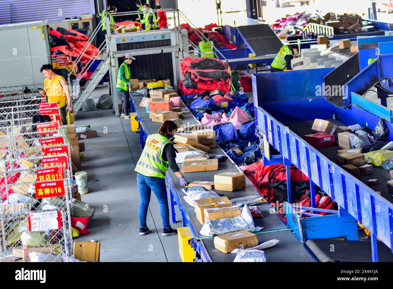 Workers are sorting parcels at a courier company in Qingzhou, East ...