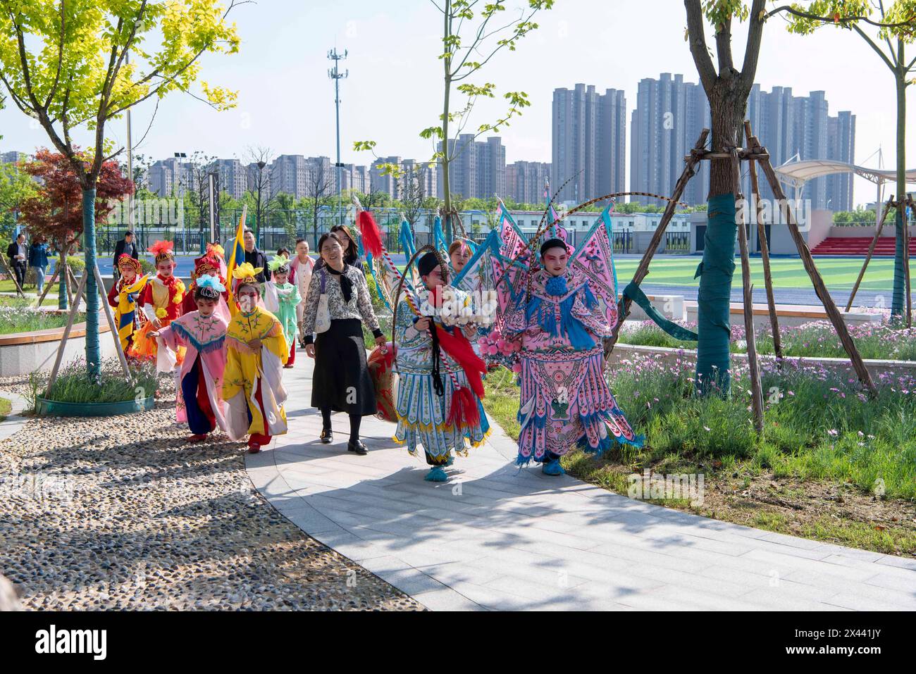 Children from a Peking Opera club are returning after a performance in ...