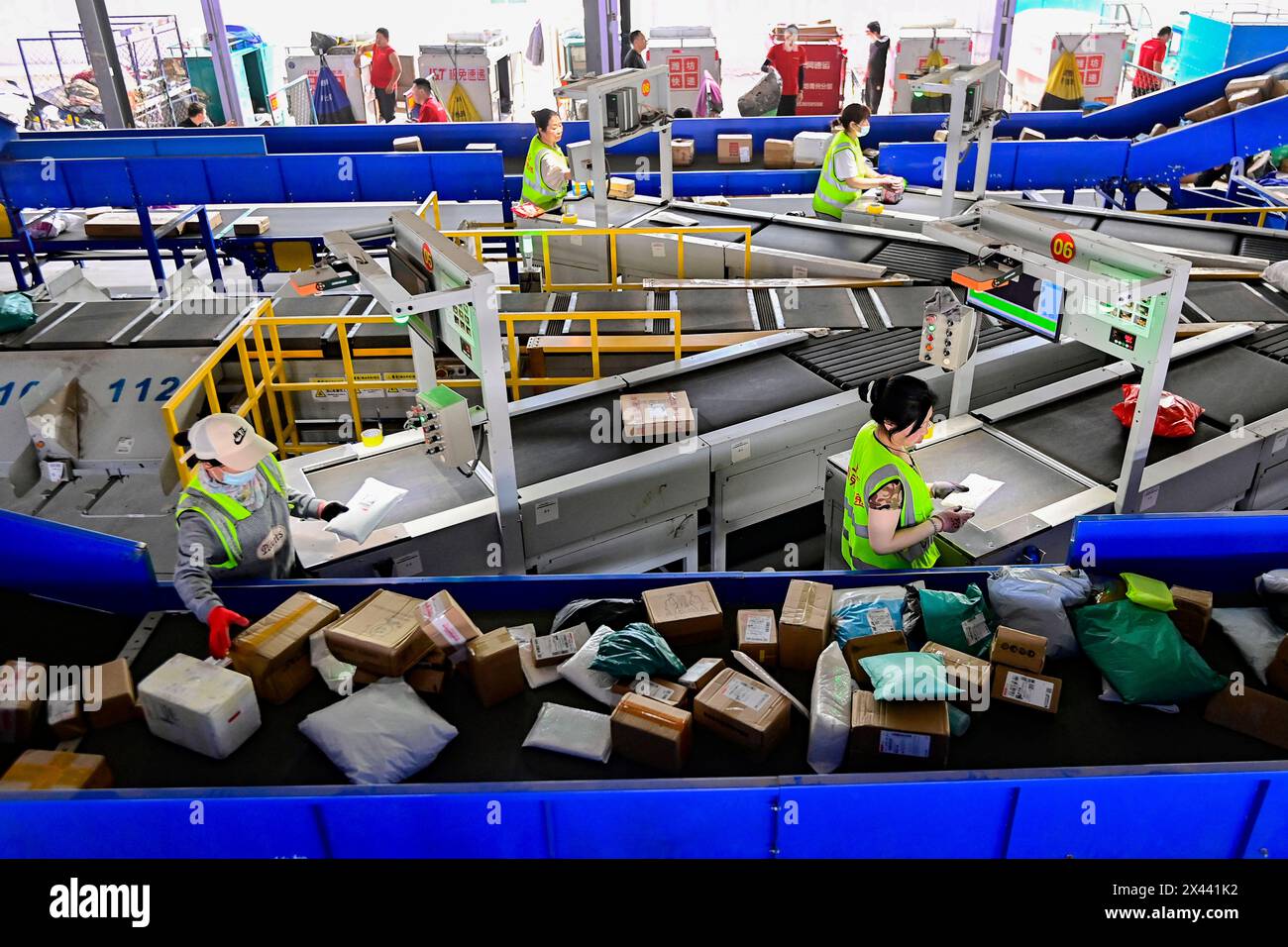 Workers are sorting parcels at a courier company in Qingzhou, East ...