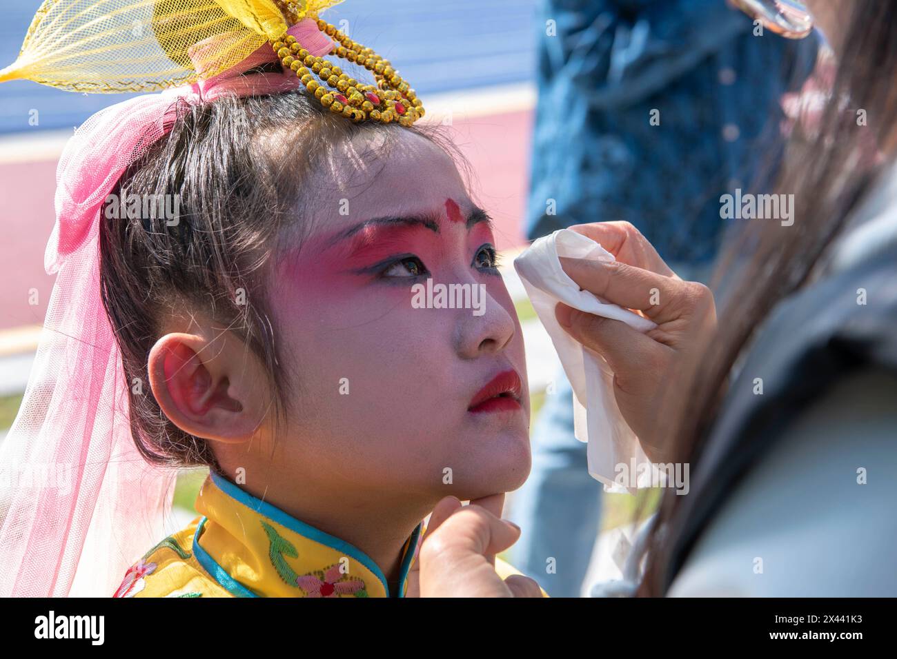 A teacher is soothing a child from a Peking Opera club in Hai'an ...
