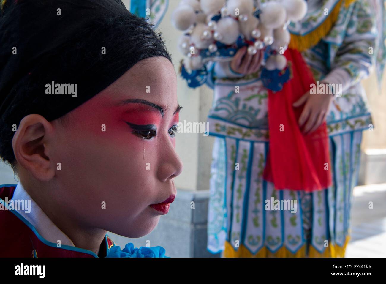 A child from the Peking Opera club is shedding tears after a ...