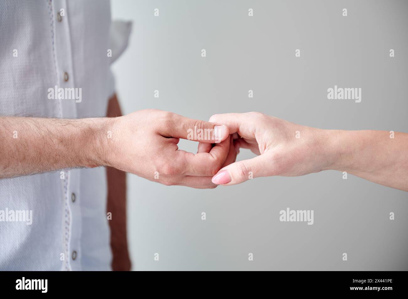 Close up of two hands engaging in delicate touch. Man's and woman's ...