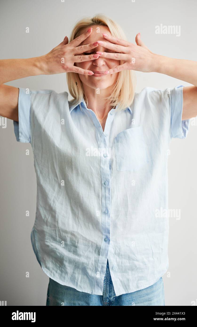 Pretty woman hiding face in her hands. Beautiful female covering face ...