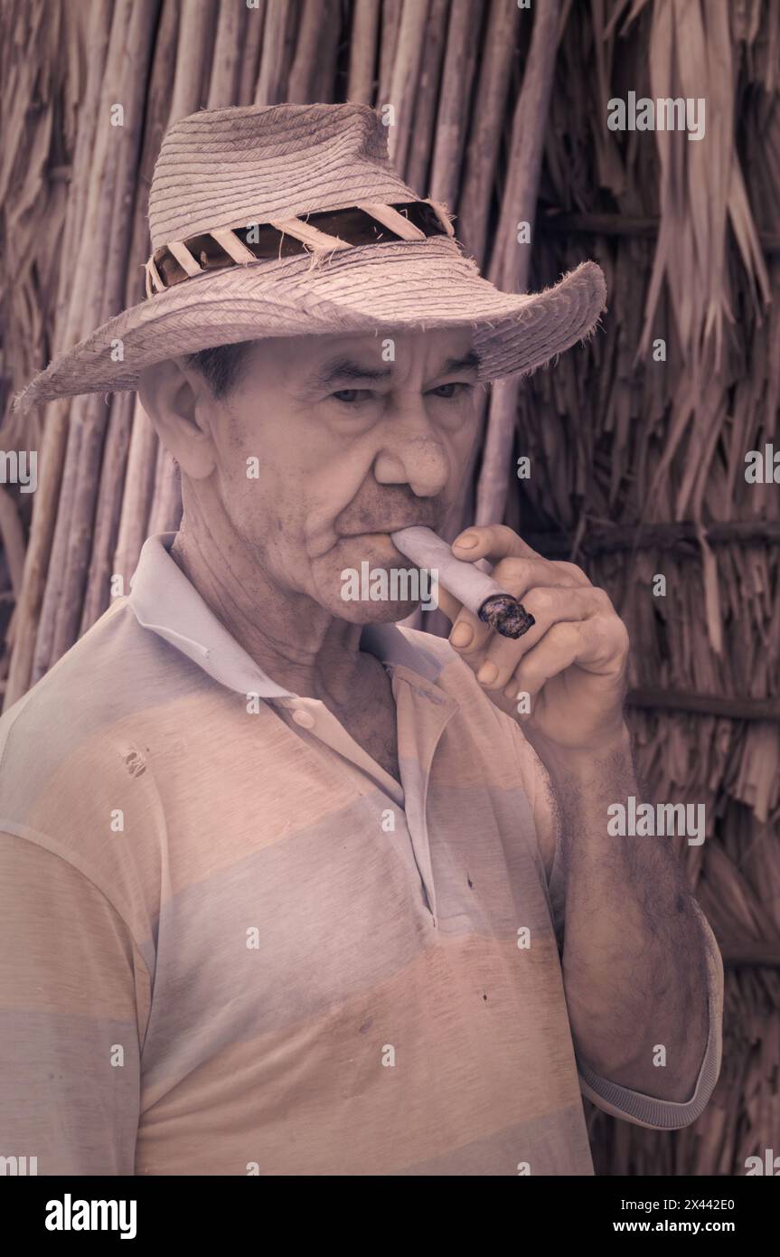 An infrared picture of a tobacco farm worker smoking a cigar outside ...