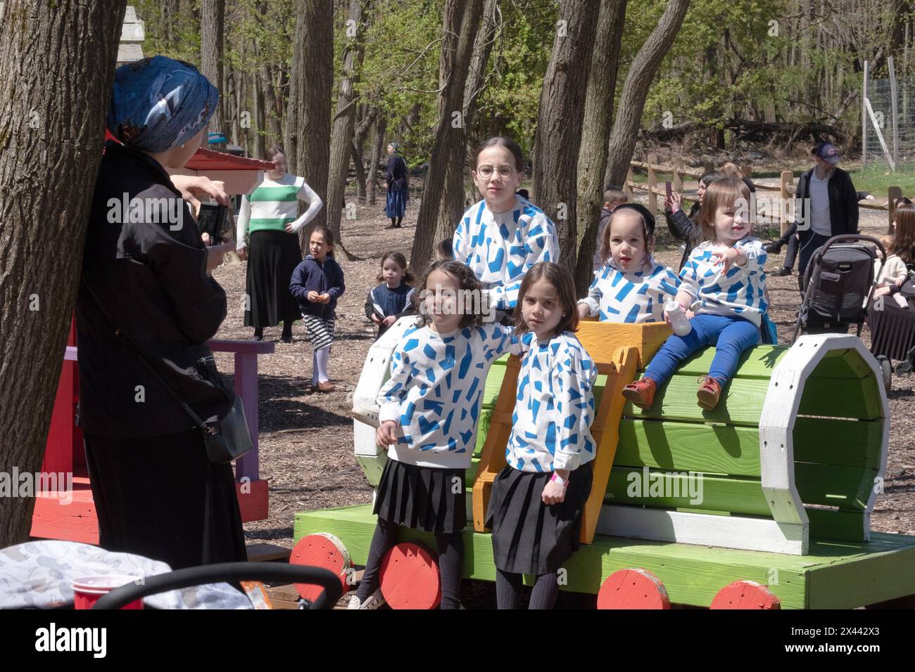 A Hasidic Jewish family with kids wearing identical tops, pose for a ...