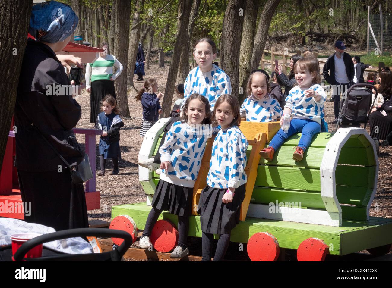 A Hasidic Jewish family with kids wearing identical tops, pose for a ...