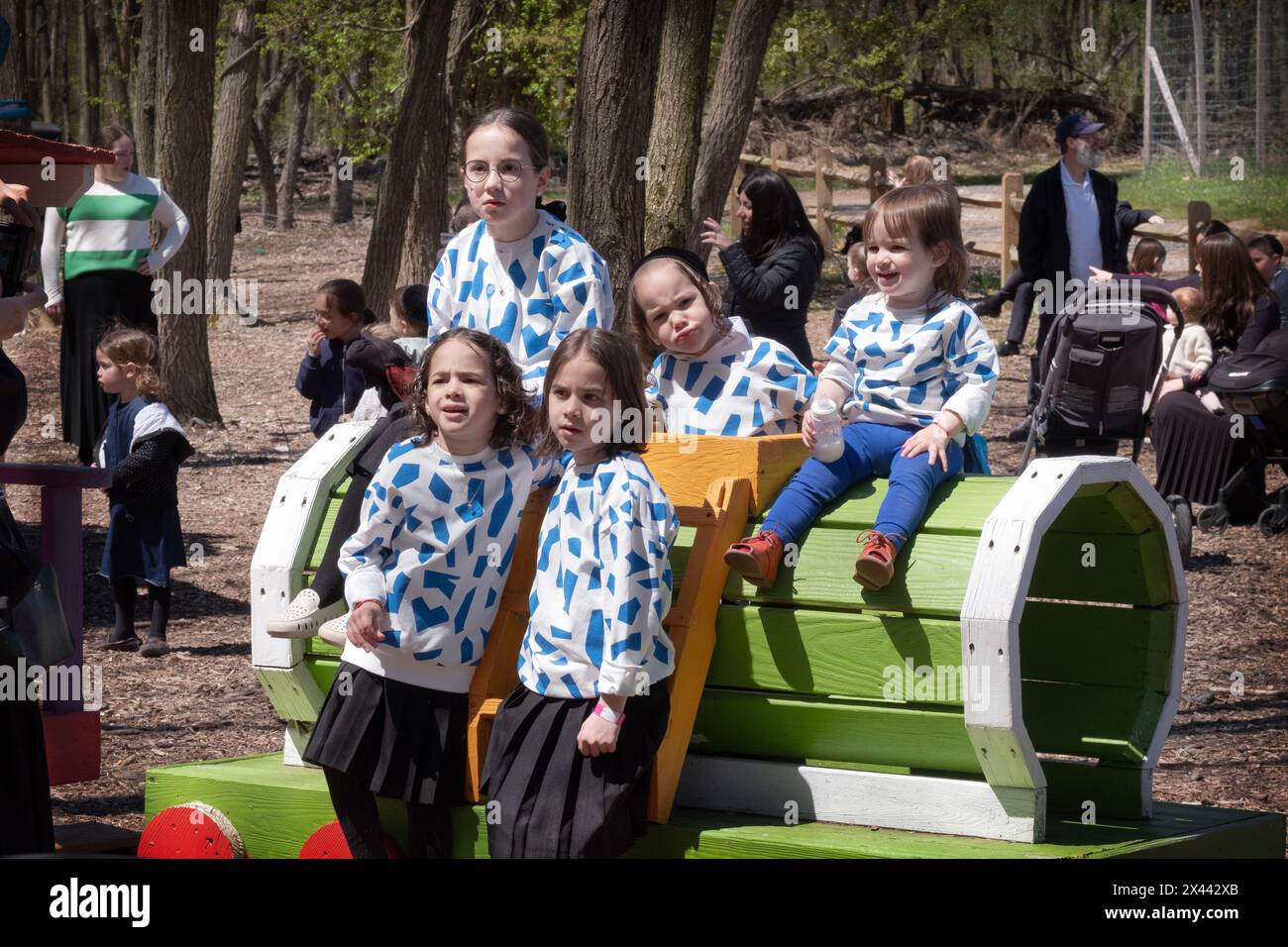 A Hasidic Jewish family with kids wearing identical tops, pose for a ...