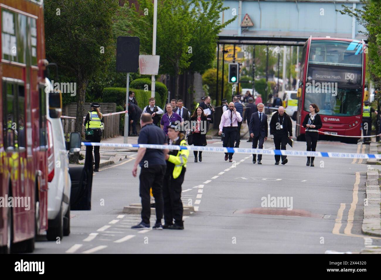 Police officers inside the cordon in Hainault, north east London, where ...