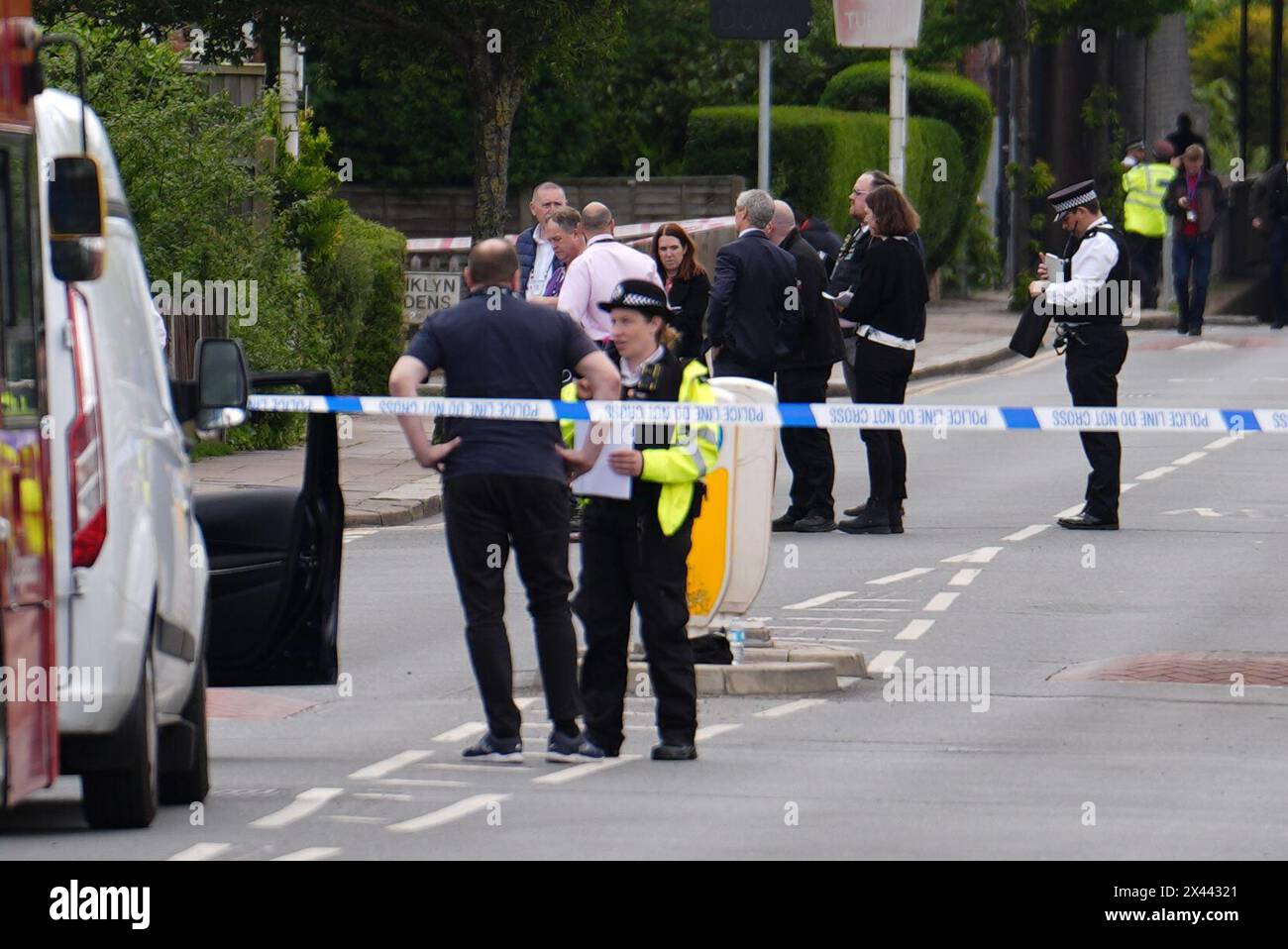 Police officers inside the cordon in Hainault, north east London, where ...