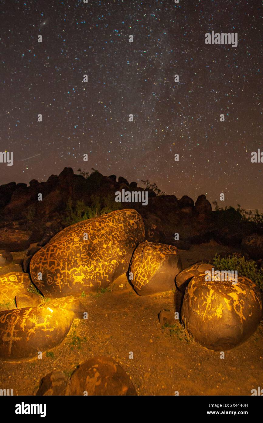 USA, Arizona, Painted Rock Petroglyph Site. Illuminated rock ...