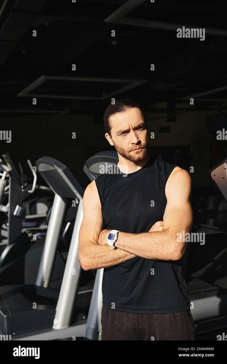 An athletic man in activewear stands confidently in front of a row of ...