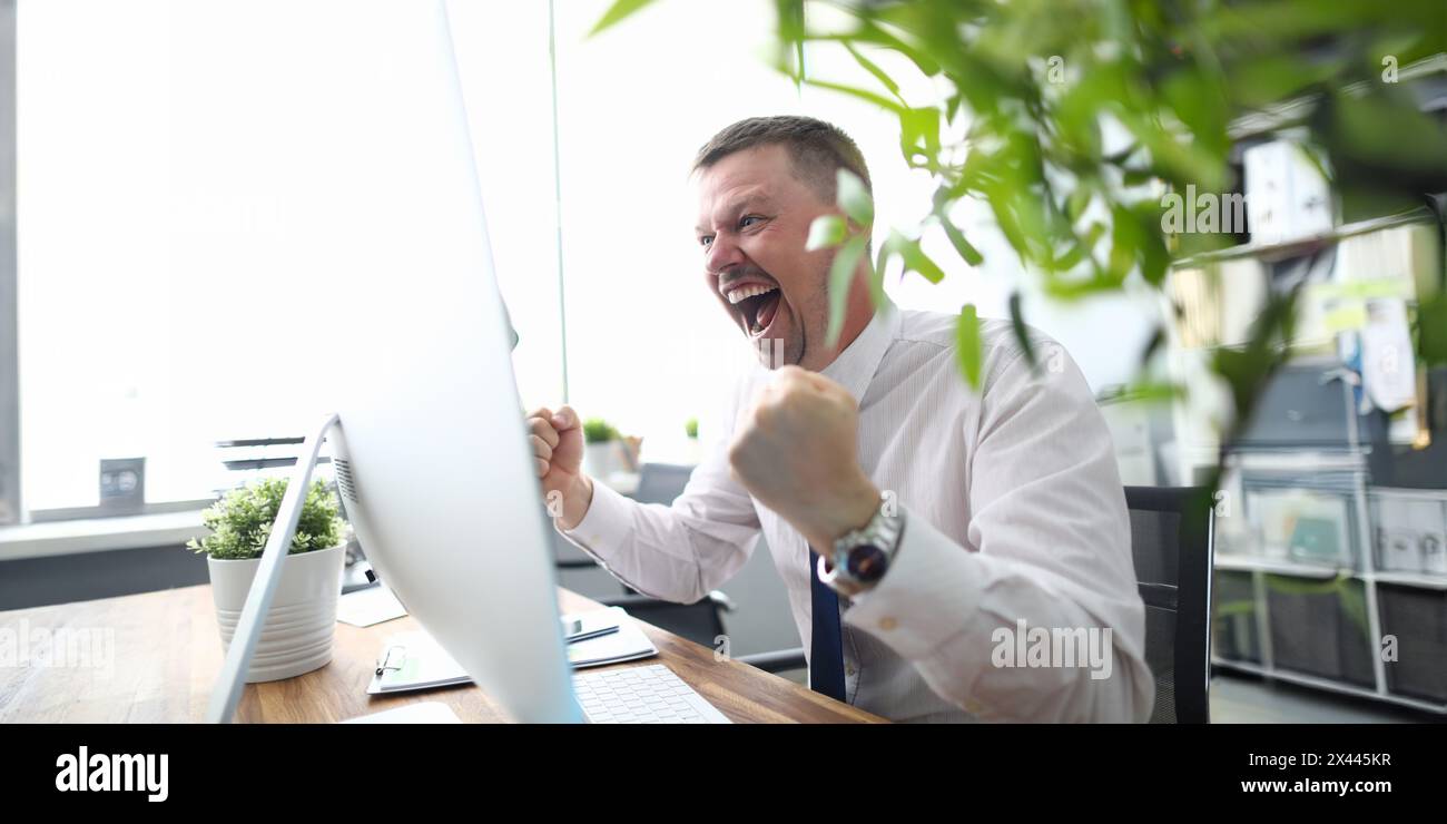 Happy manager at workplace Stock Photo - Alamy