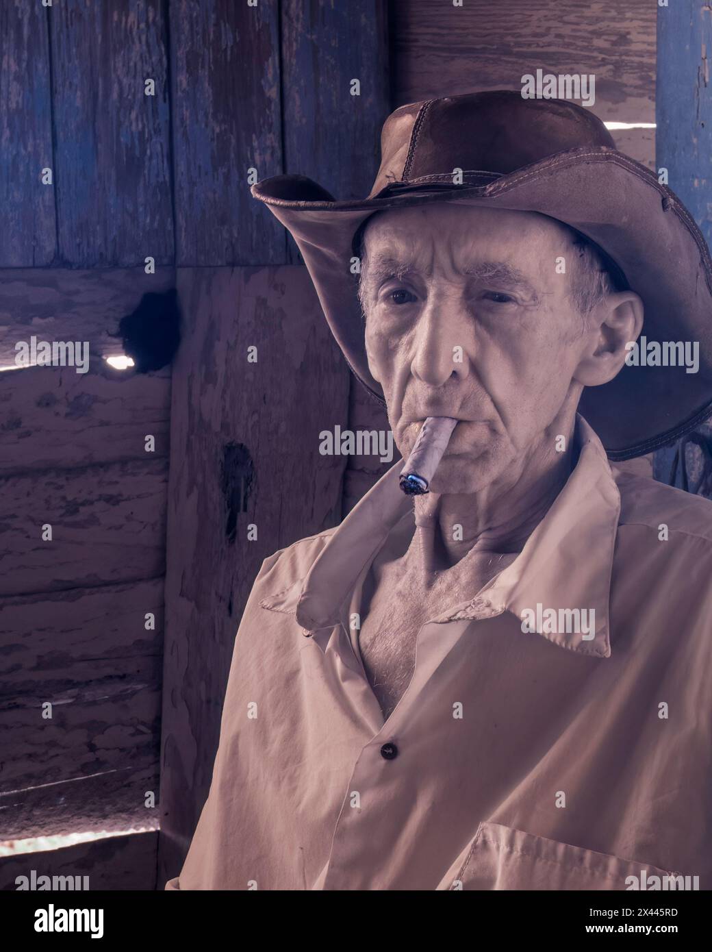 An infrared picture of a coffee farmer smoking a cigar in his farmhouse ...
