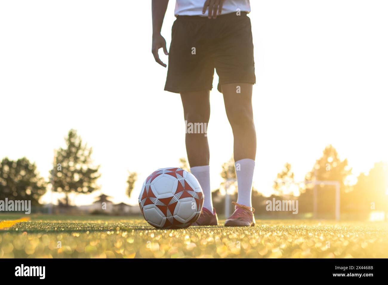 Down section soccer palyer foot and ball in the grass of soccer field ...