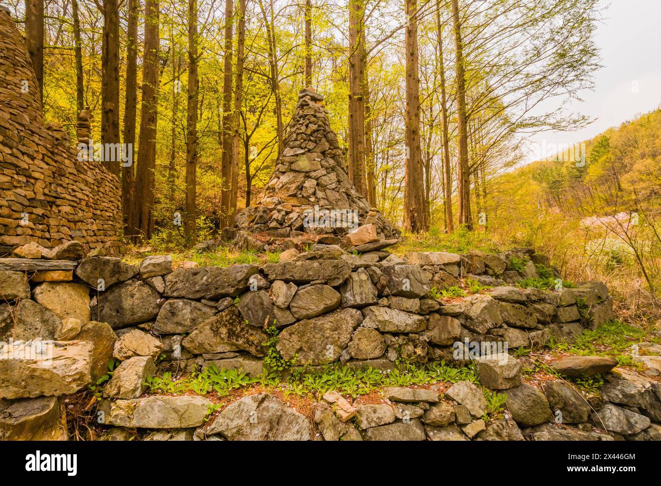 Stone cone shaped tower in small tree lined park near Sejeonggol, South ...