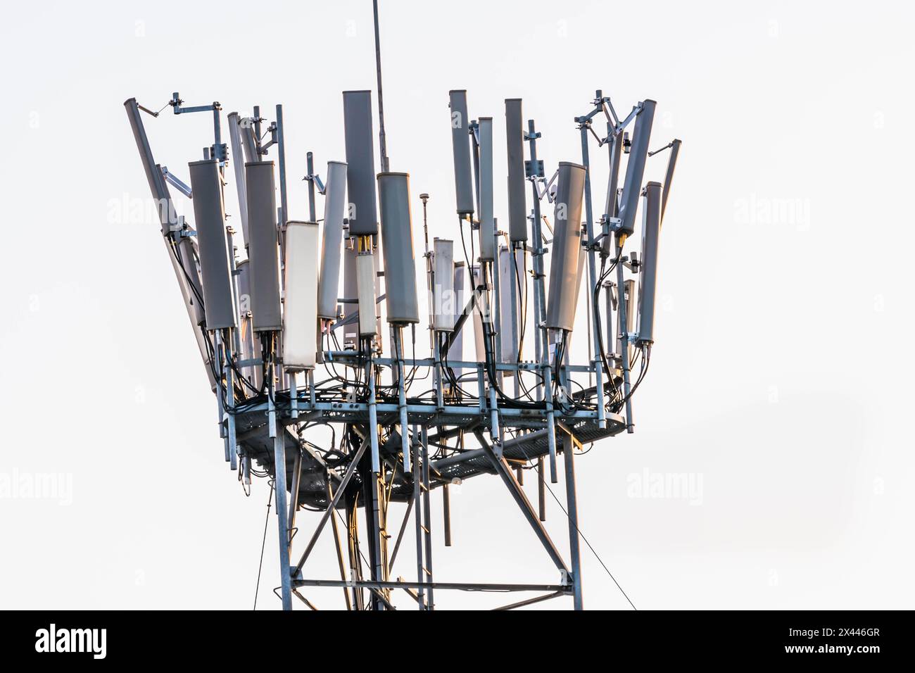 Top of large communication tower against a dull white sky in South ...
