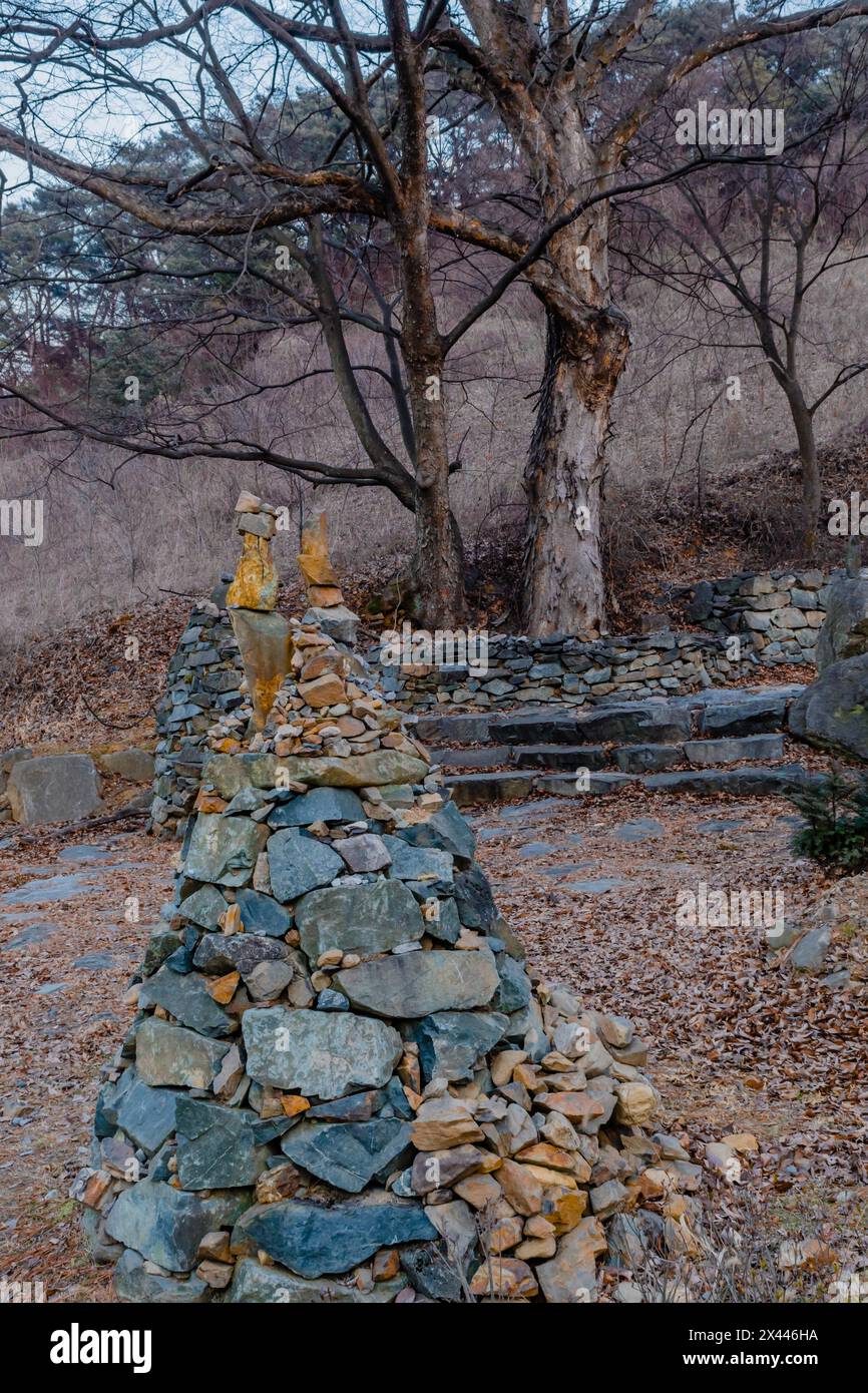 Upside down cone shaped tower of rocks and stones in rural roadside ...