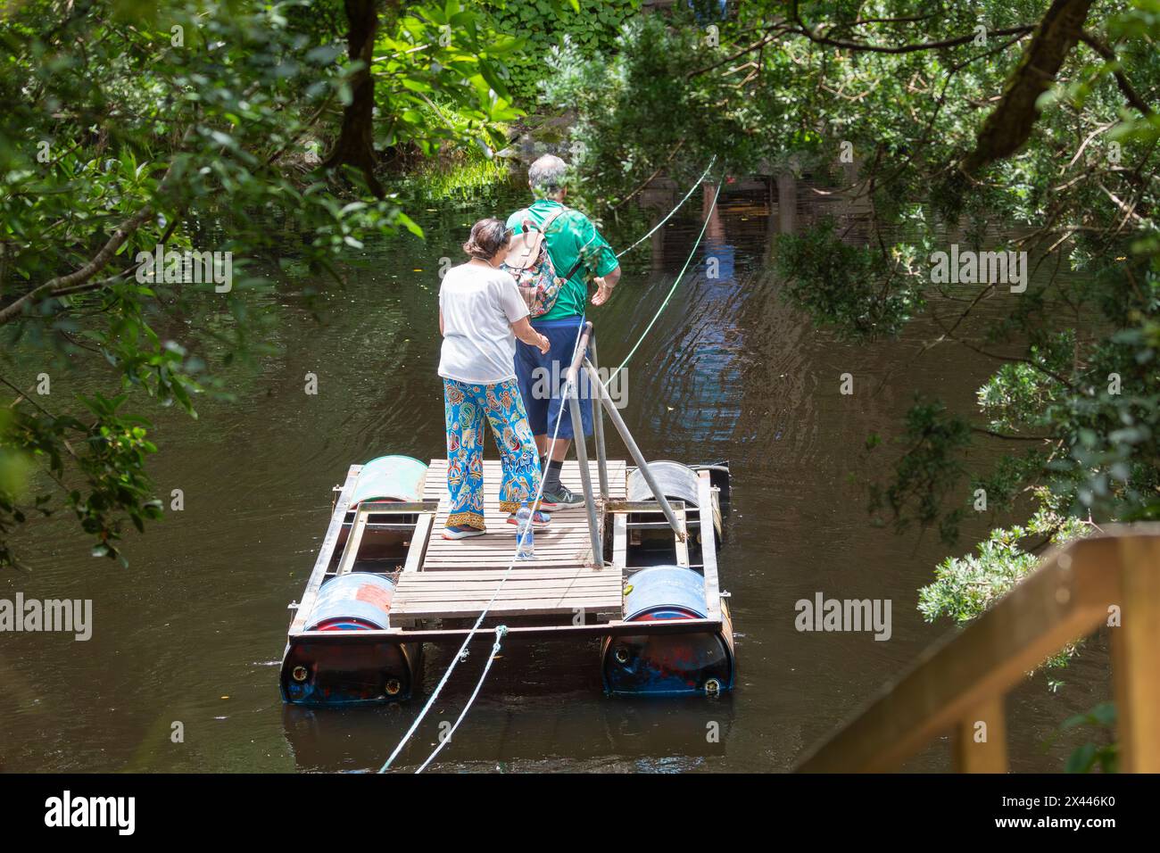 Tourists using a pontoon to cross the Touw River, Wilderness, South ...