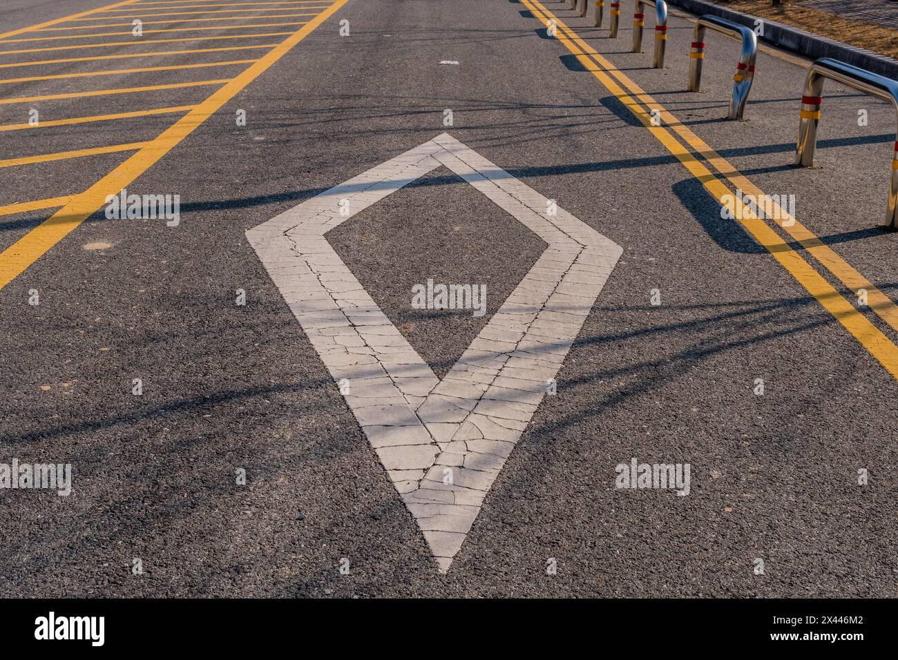 White diamond shape painted on pavement between two yellow lines in ...