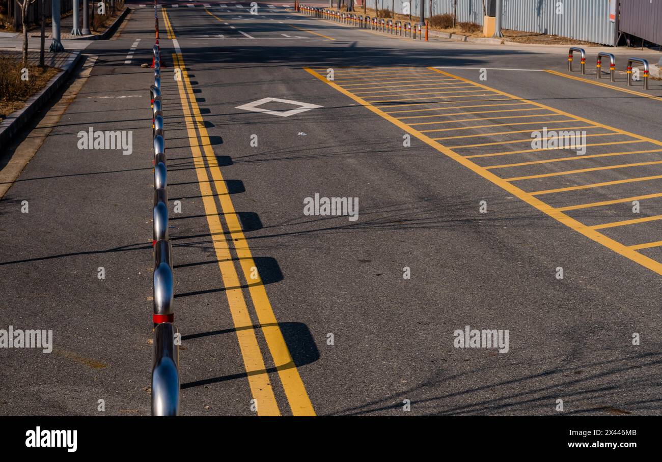 Chrome metal traffic barriers separating bicycle lane from automobile ...