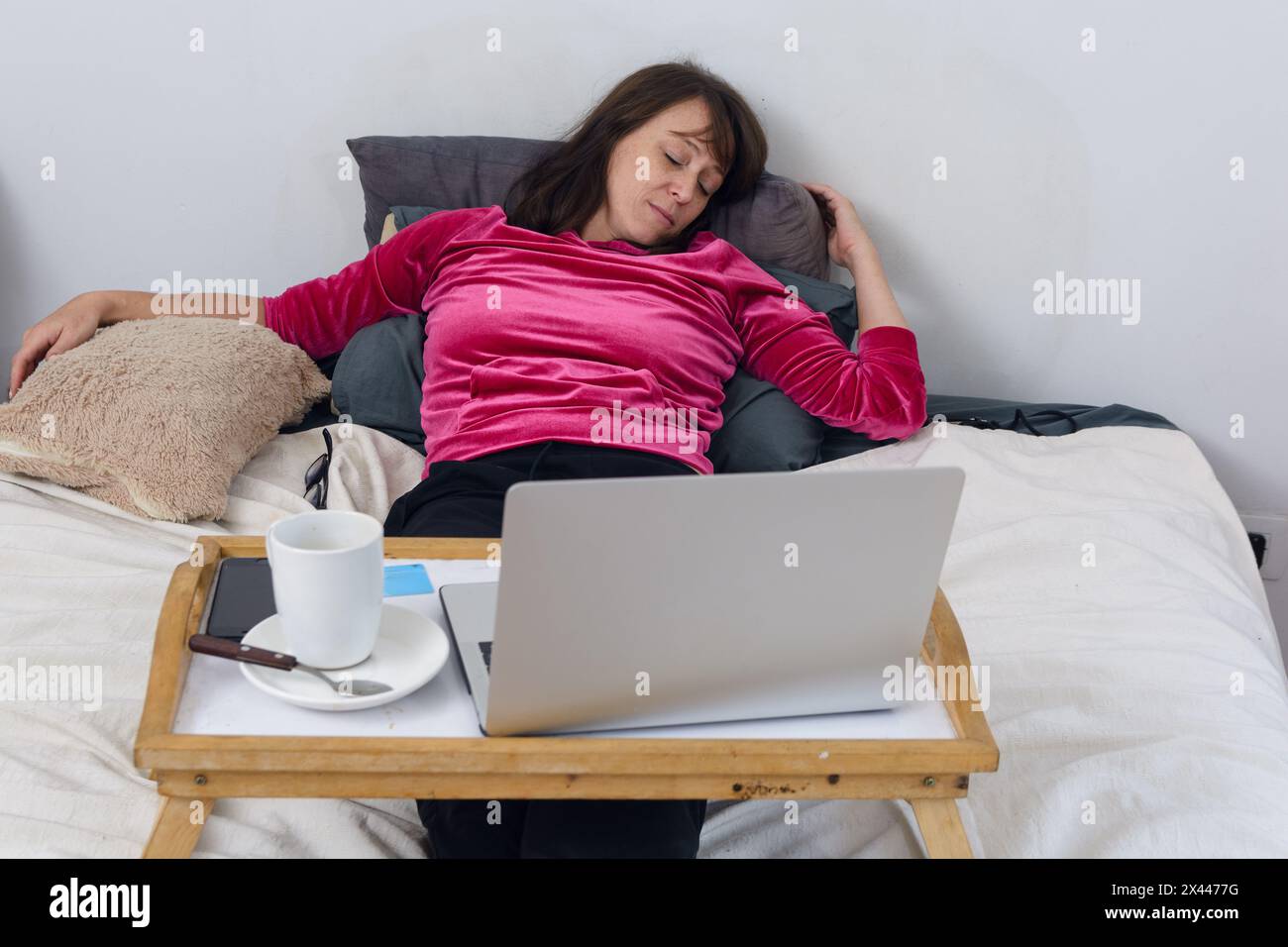 very comfortable latin adult woman lying on bed in her room she fell ...