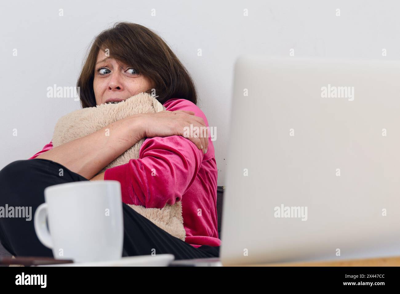 Adult Latin Woman In Pajamas Lying In Bed She Is Very Scared Hugging Pillow With Terrified Face