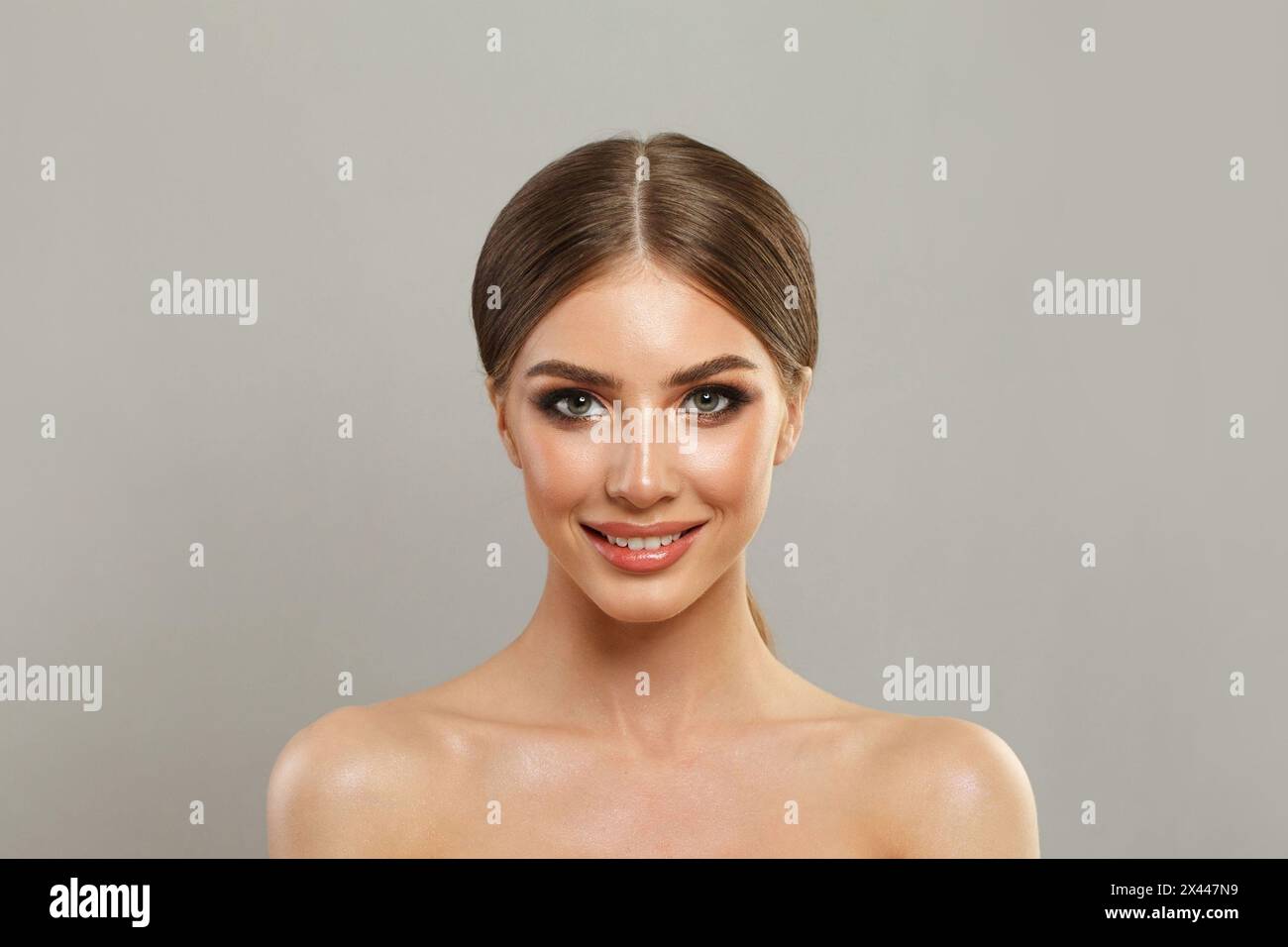 Elegant young woman with fresh silky skin posing on white background ...