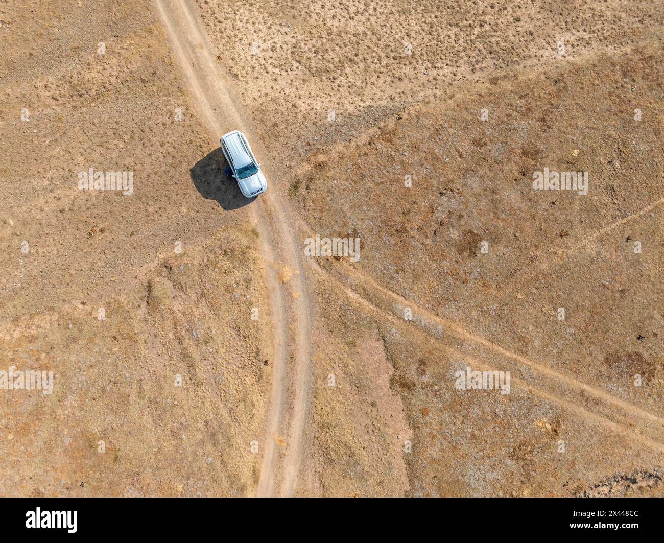 Aerial view, Vast empty landscape, Road and off-road vehicle, Top down ...