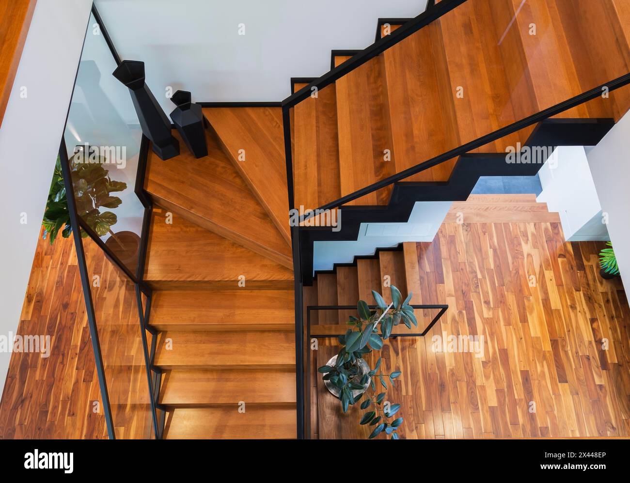 Top view of black powder coated steel L-shaped staircase with stained ...