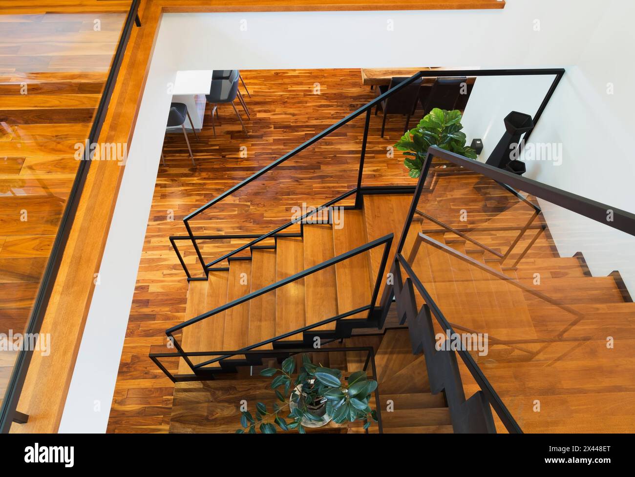 Top view of black powder coated steel L-shaped staircase with stained ...