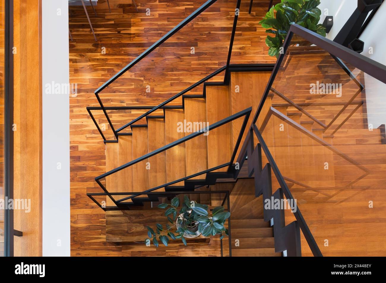 Top view of black powder coated steel L-shaped staircase with stained ...