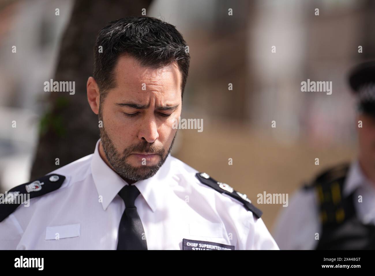 Chief Superintendent Stuart Bell reads a statement to the media near ...