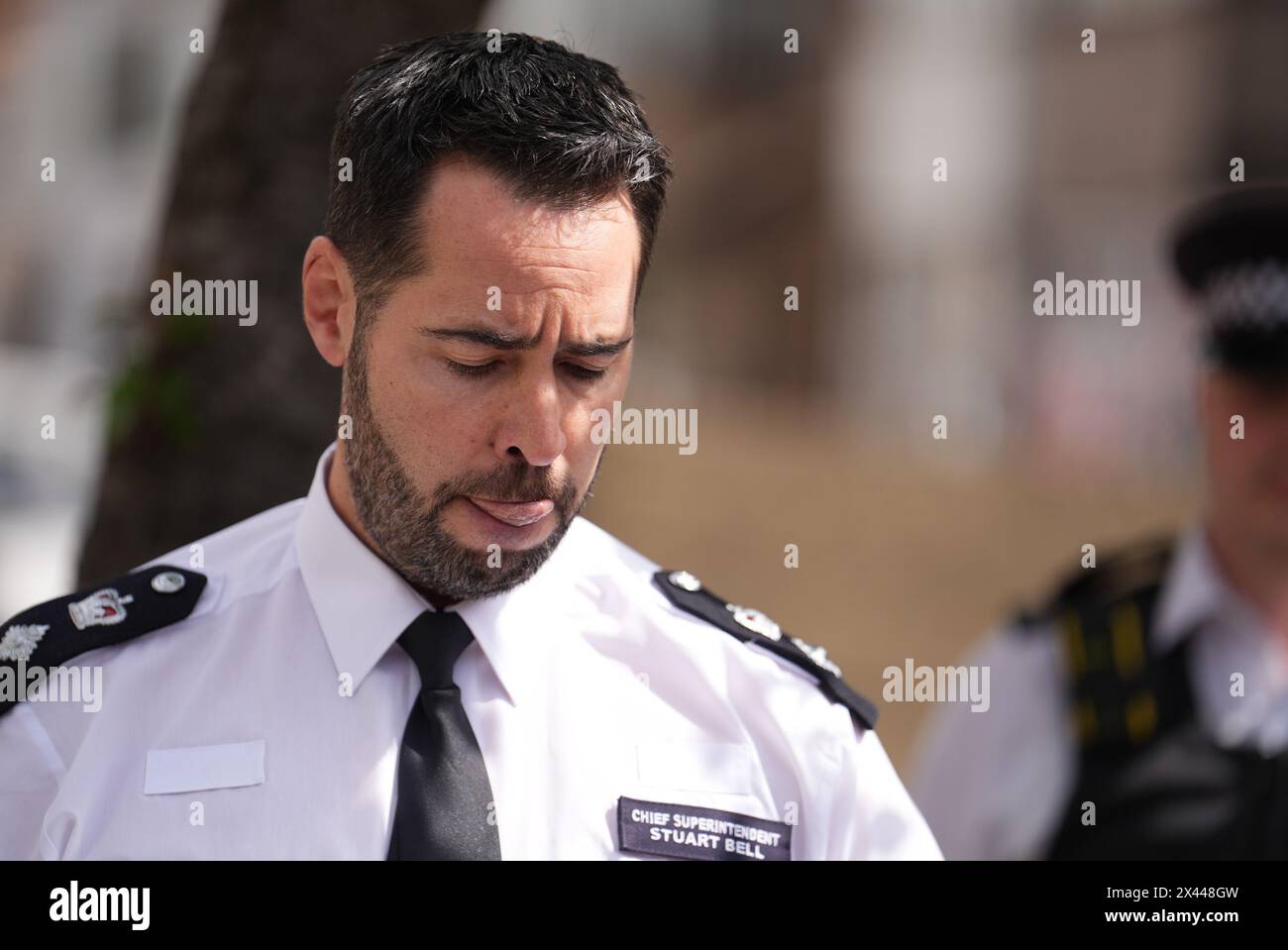 Chief Superintendent Stuart Bell reads a statement to the media near ...