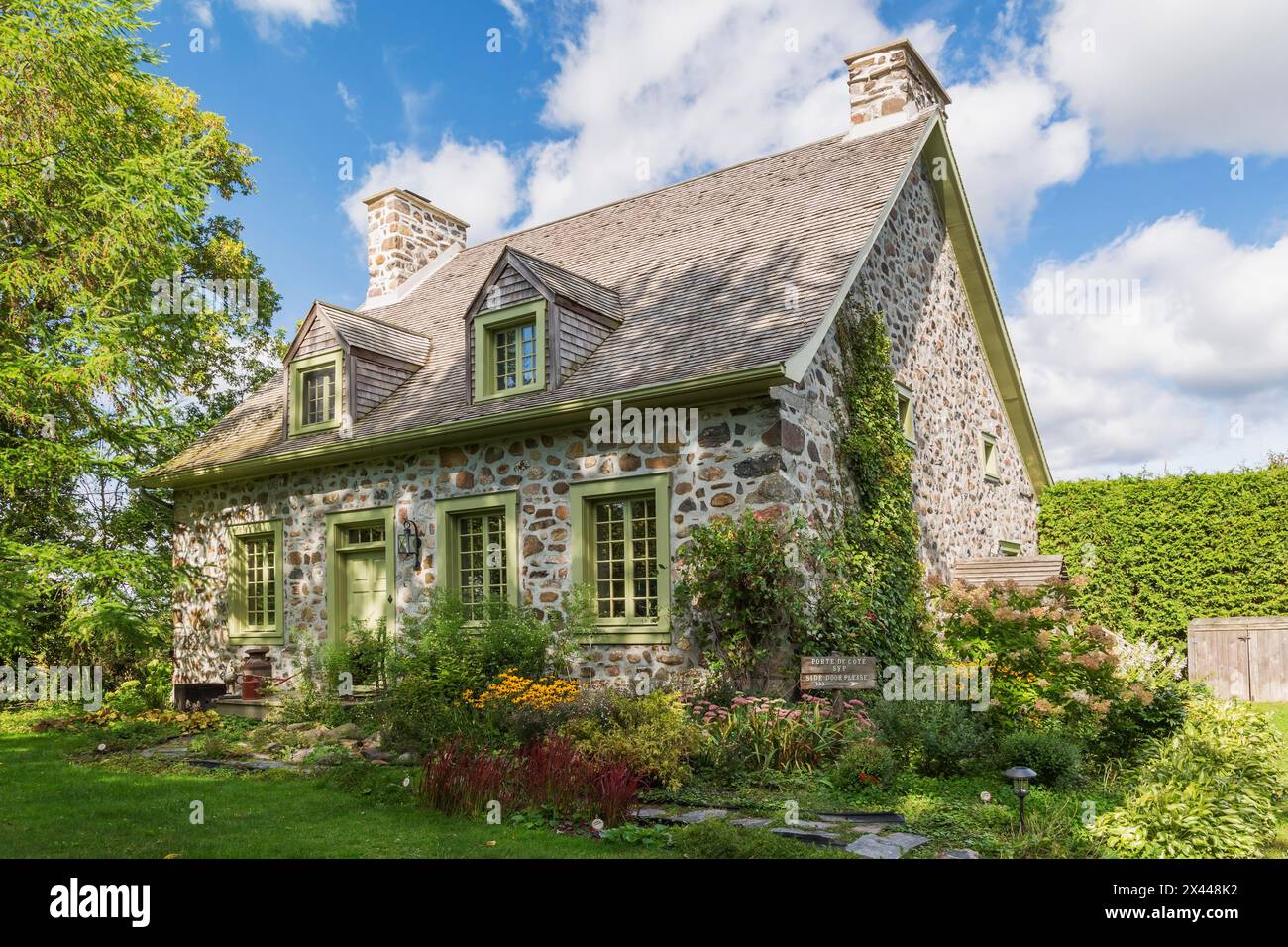 Old circa 1735 Canadiana fieldstone house facade with lime green trim ...