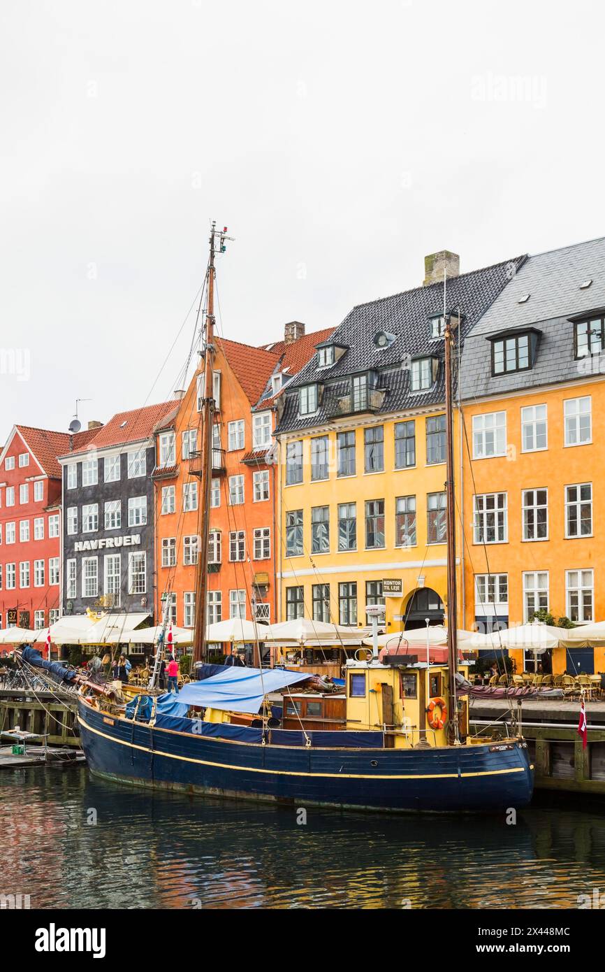Colourful 17th century apartment buildings and houses with moored blue ...