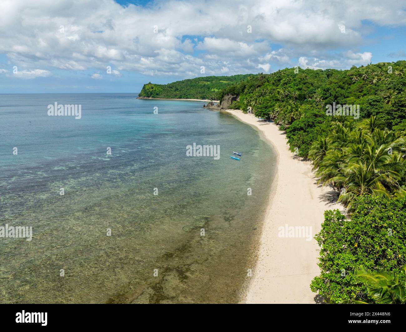 White sand in tropical beach and transparent sea water with boats ...