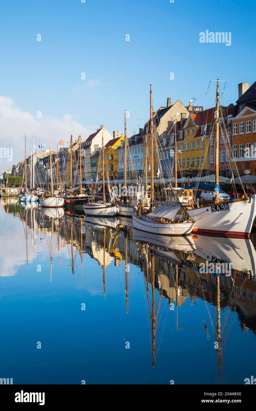 Moored sailboats and colourful 17th century apartment buildings and ...