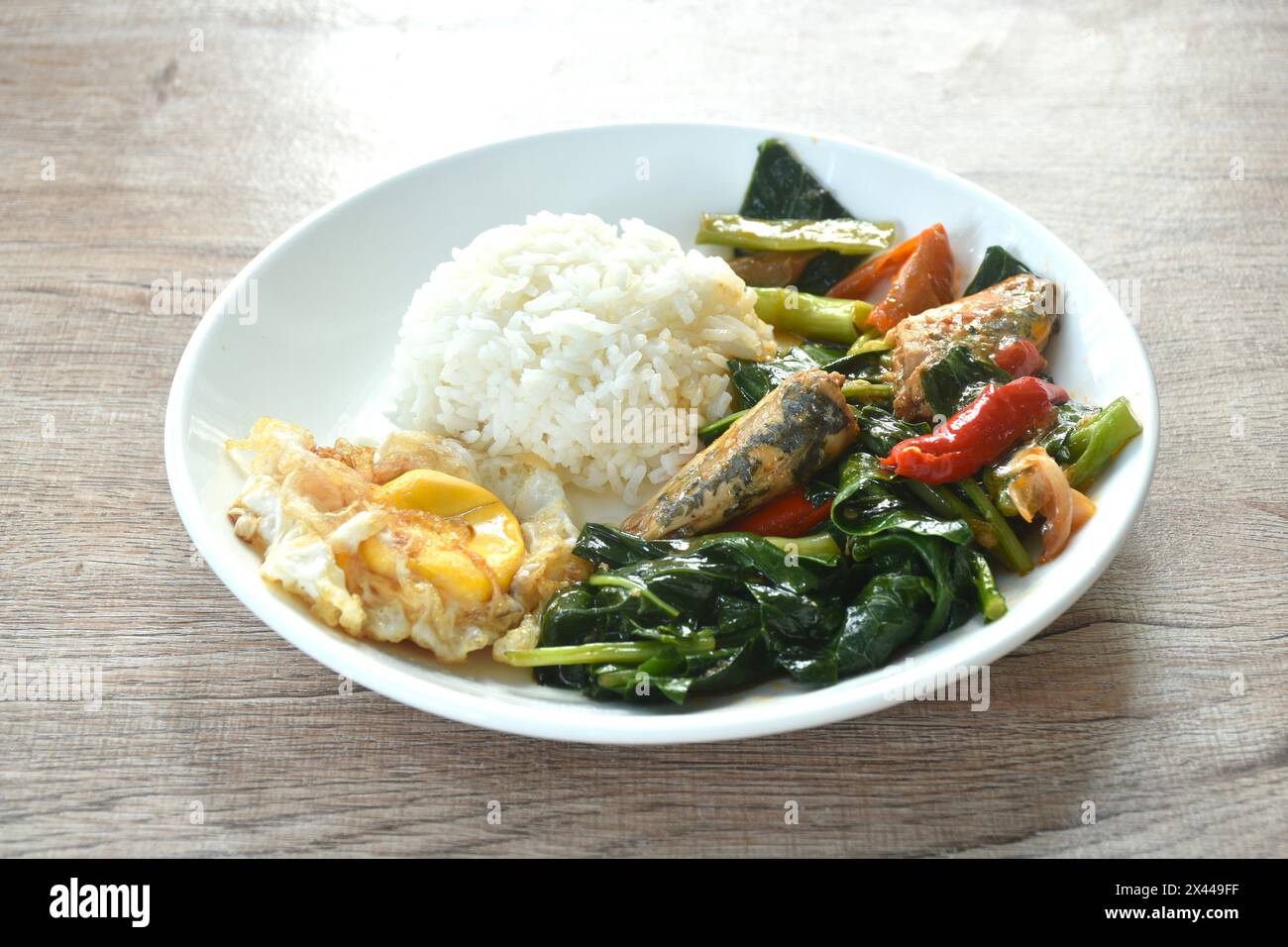 spicy stir fried Chinese kale with fish can in tomato sauce topping egg ...