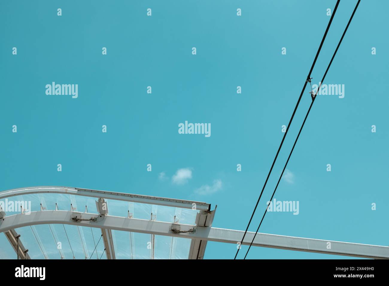 Overhead train power line and station awning Stock Photo - Alamy