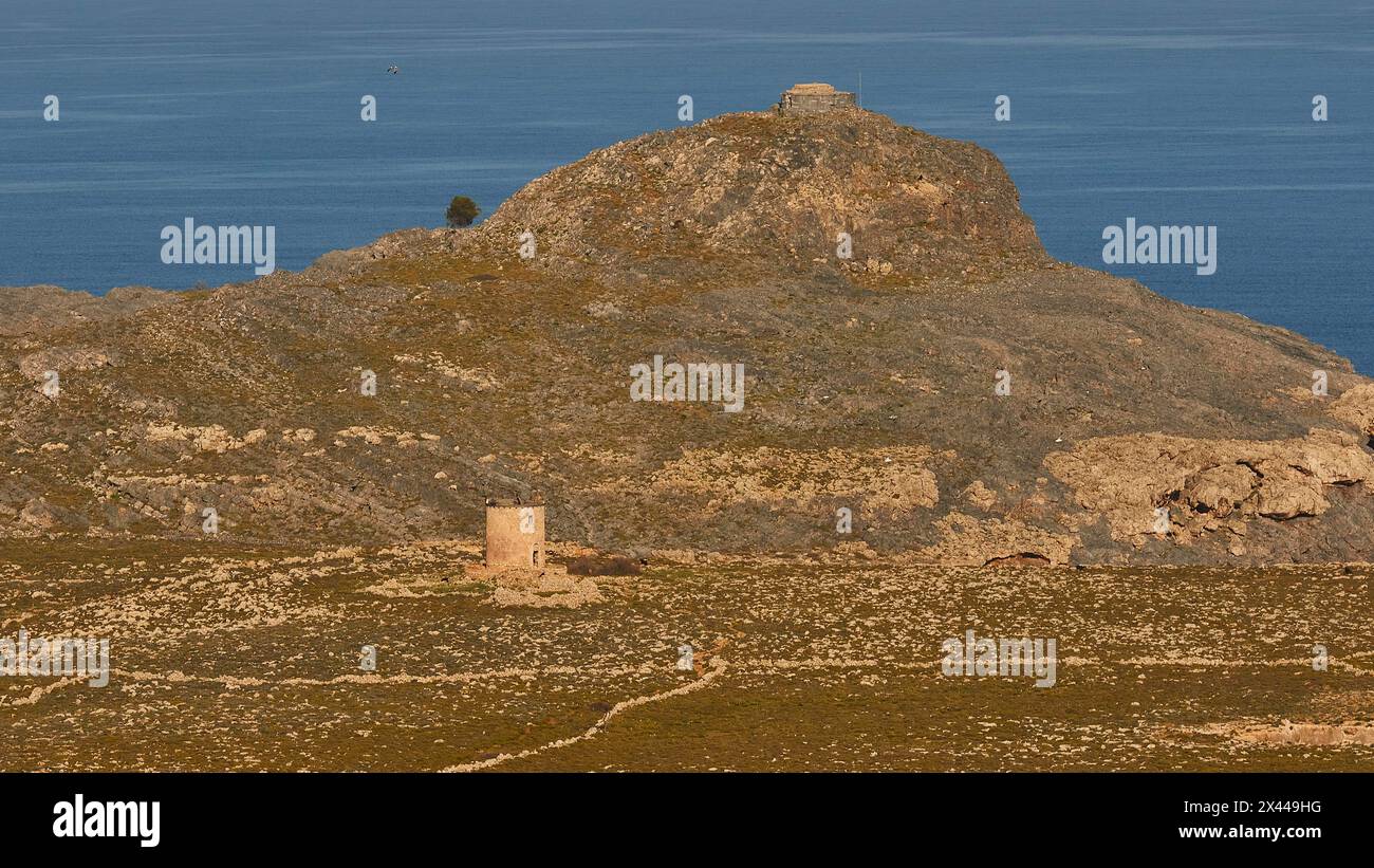 Ruins of a windmill, Hilly landscape with historical ruins and a path ...