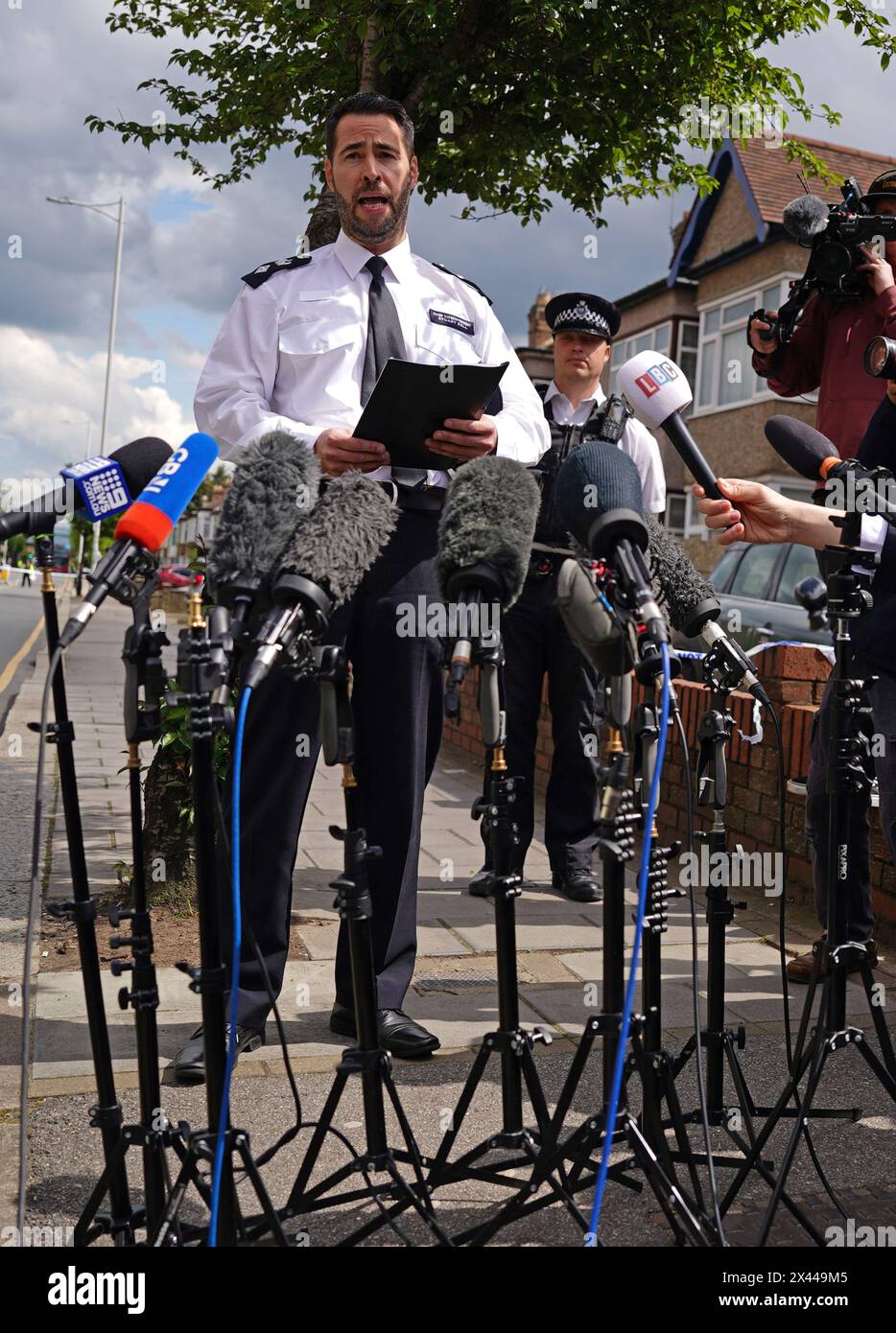 Chief Superintendent Stuart Bell reads a statement to the media near ...