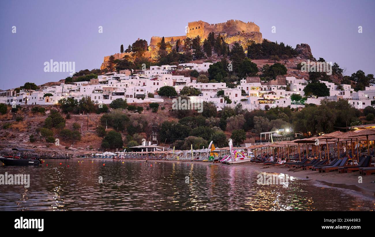 Evening view of a Greek village with ancient castle above the sea ...