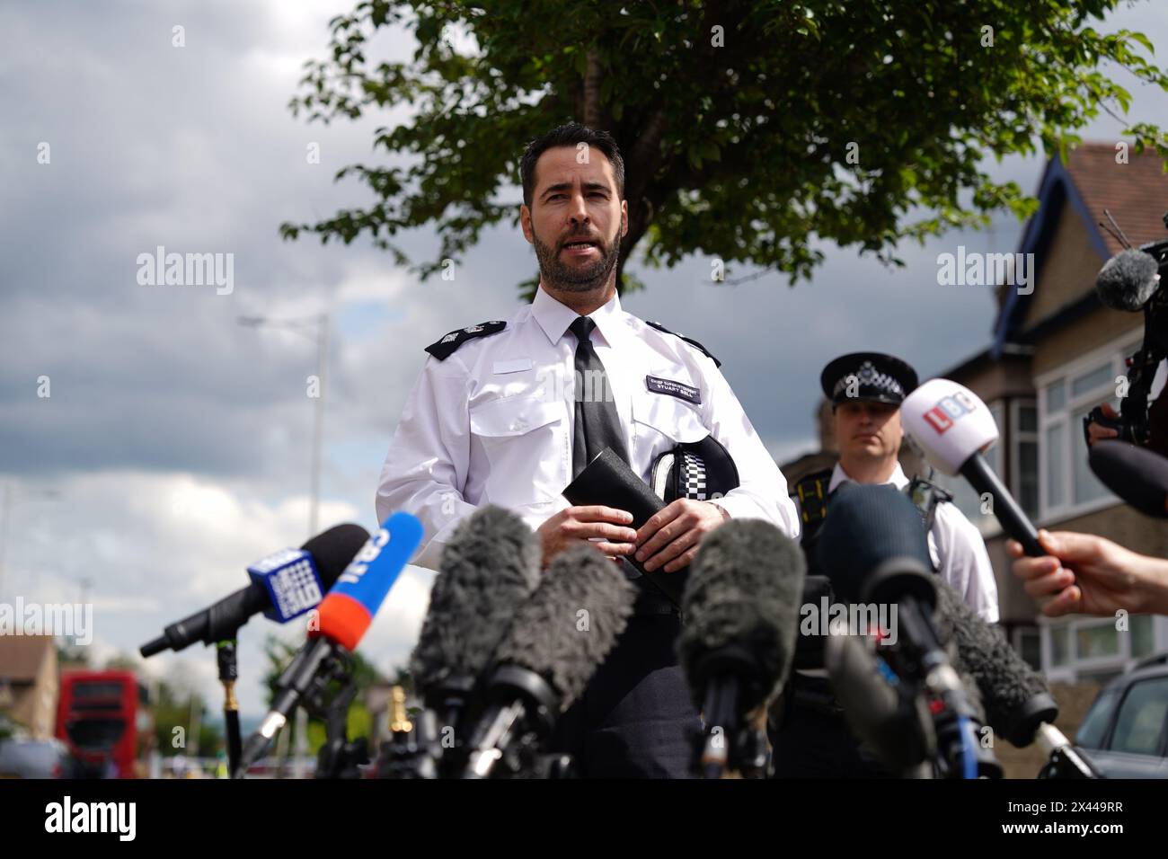 Chief Superintendent Stuart Bell reads a statement to the media near the scene in Hainault ...