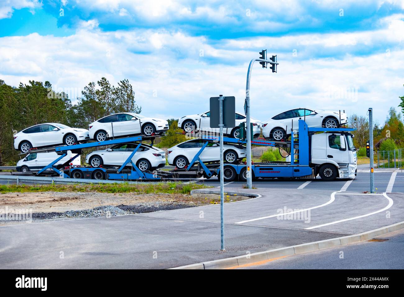 semi-truck transports load white Tesla ehicles from Gigafactory Berlin ...