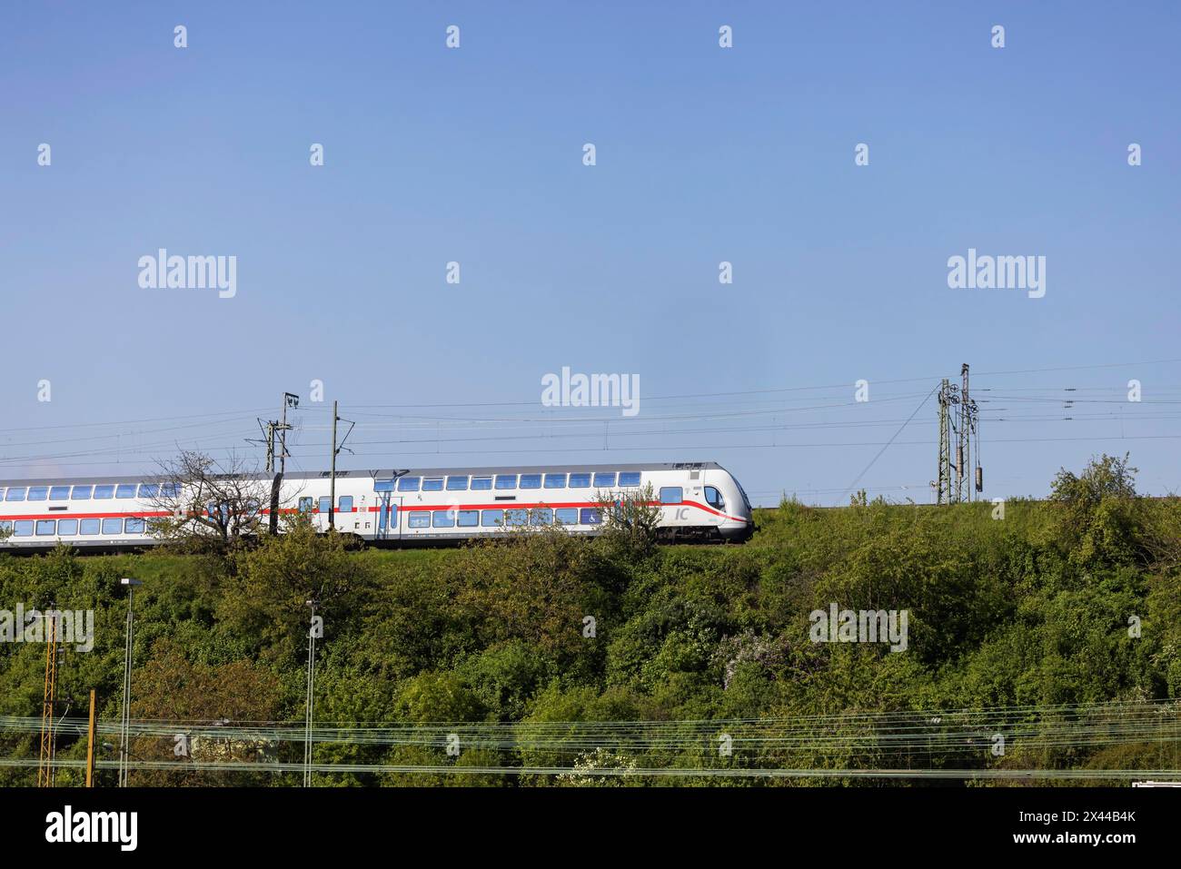 Deutsche Bahn AG InterCity en route, railway embankment and overhead ...