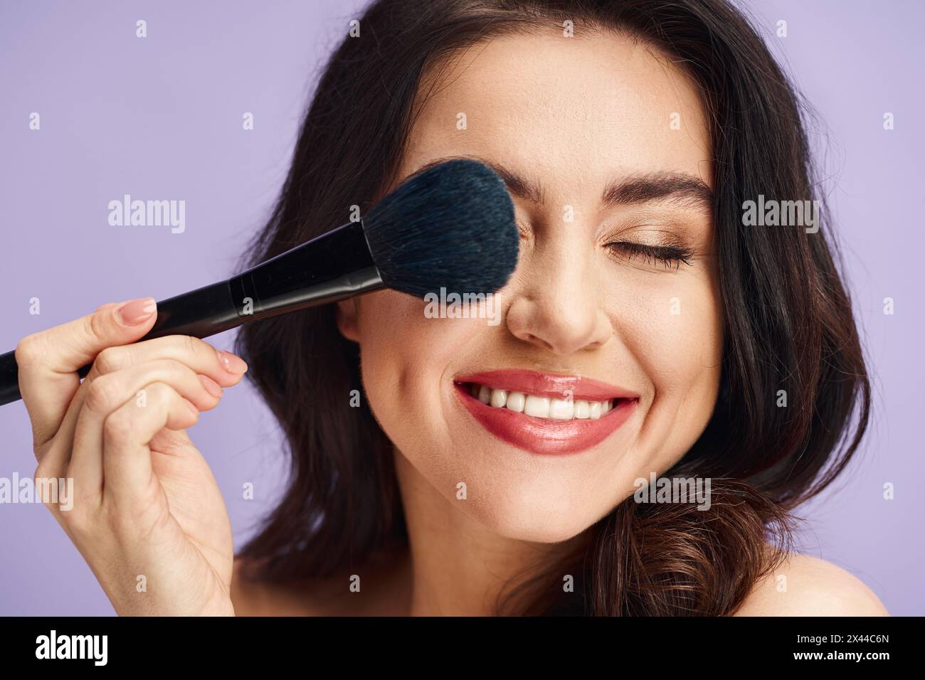 A woman enhancing her natural beauty with makeup application Stock ...