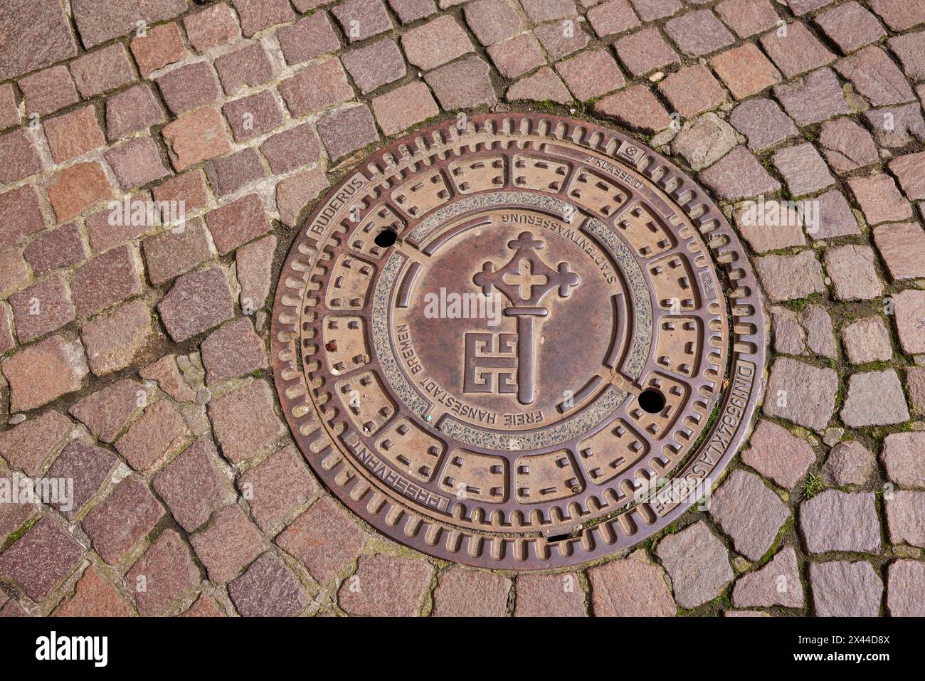 Manhole cover with the Bremen key on a paved square in Bremen ...