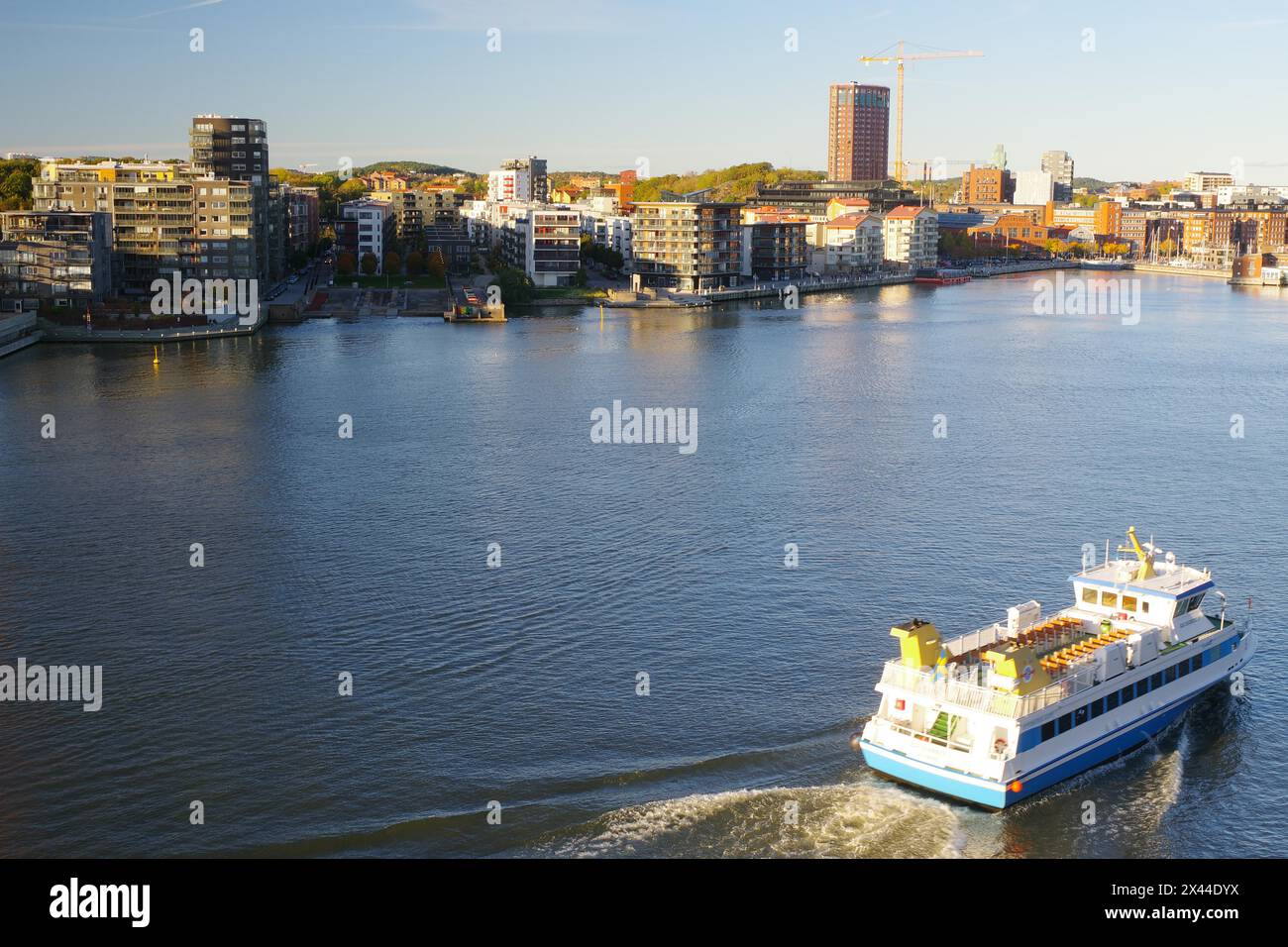 Small passenger ferry and high-rise buildings in the harbour of ...