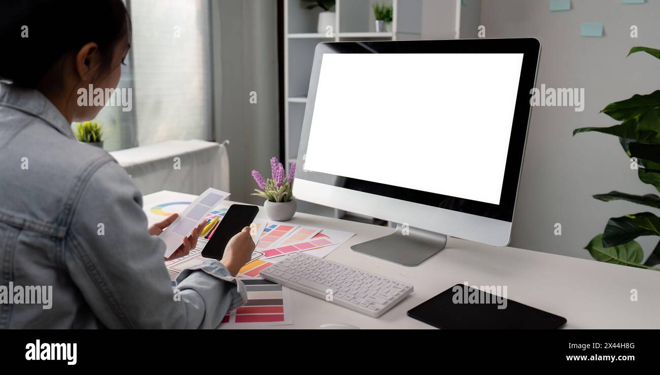 Woman sit at workplace desk with digital graphic staring at computer ...