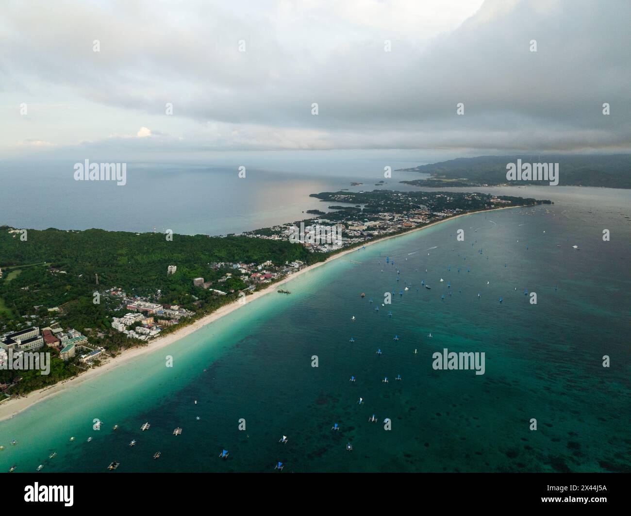 Aerial view of white beach path with powdery sands. Boats over clear ...
